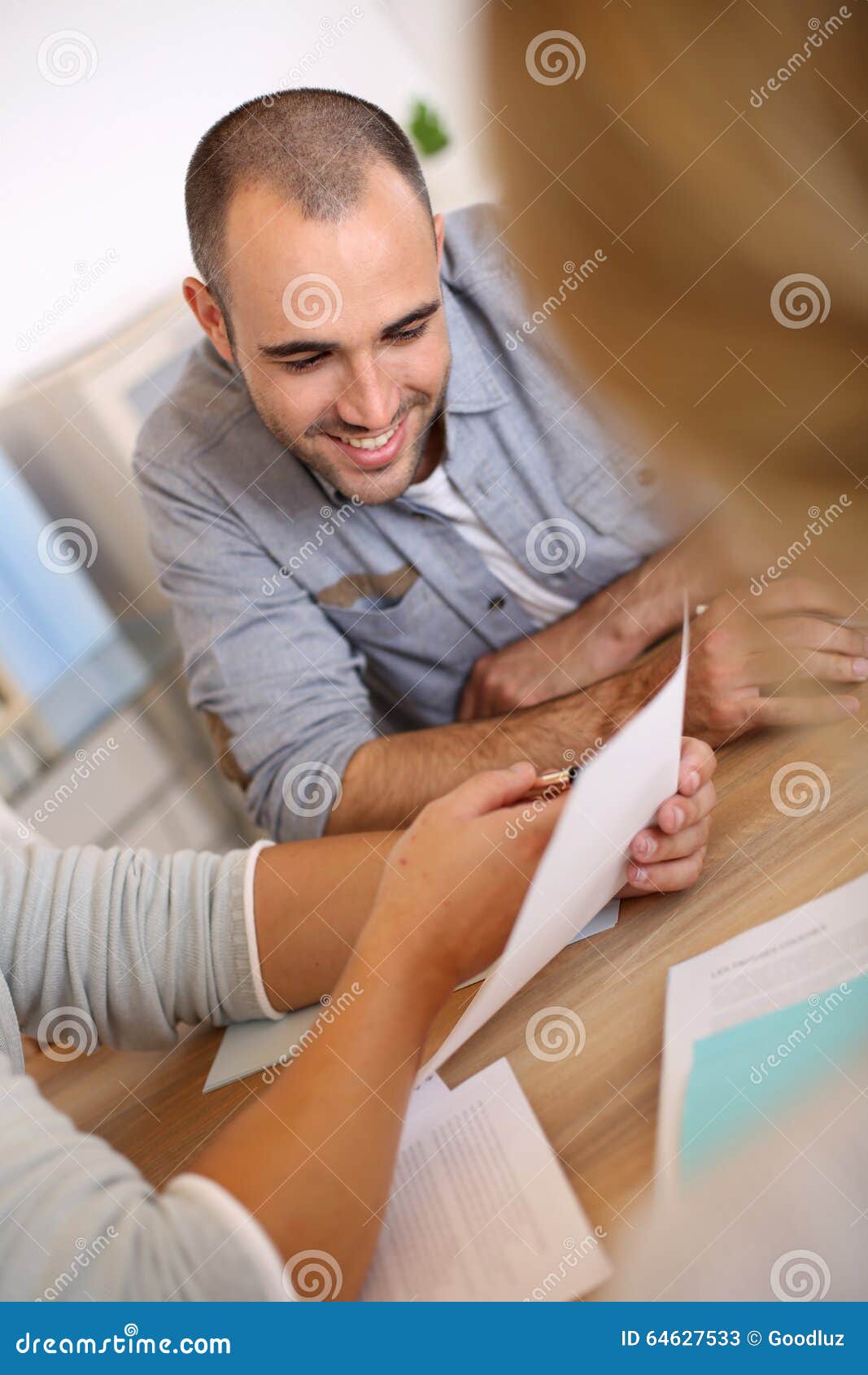 Young man reading contract stock image. Image of handsome - 64627533