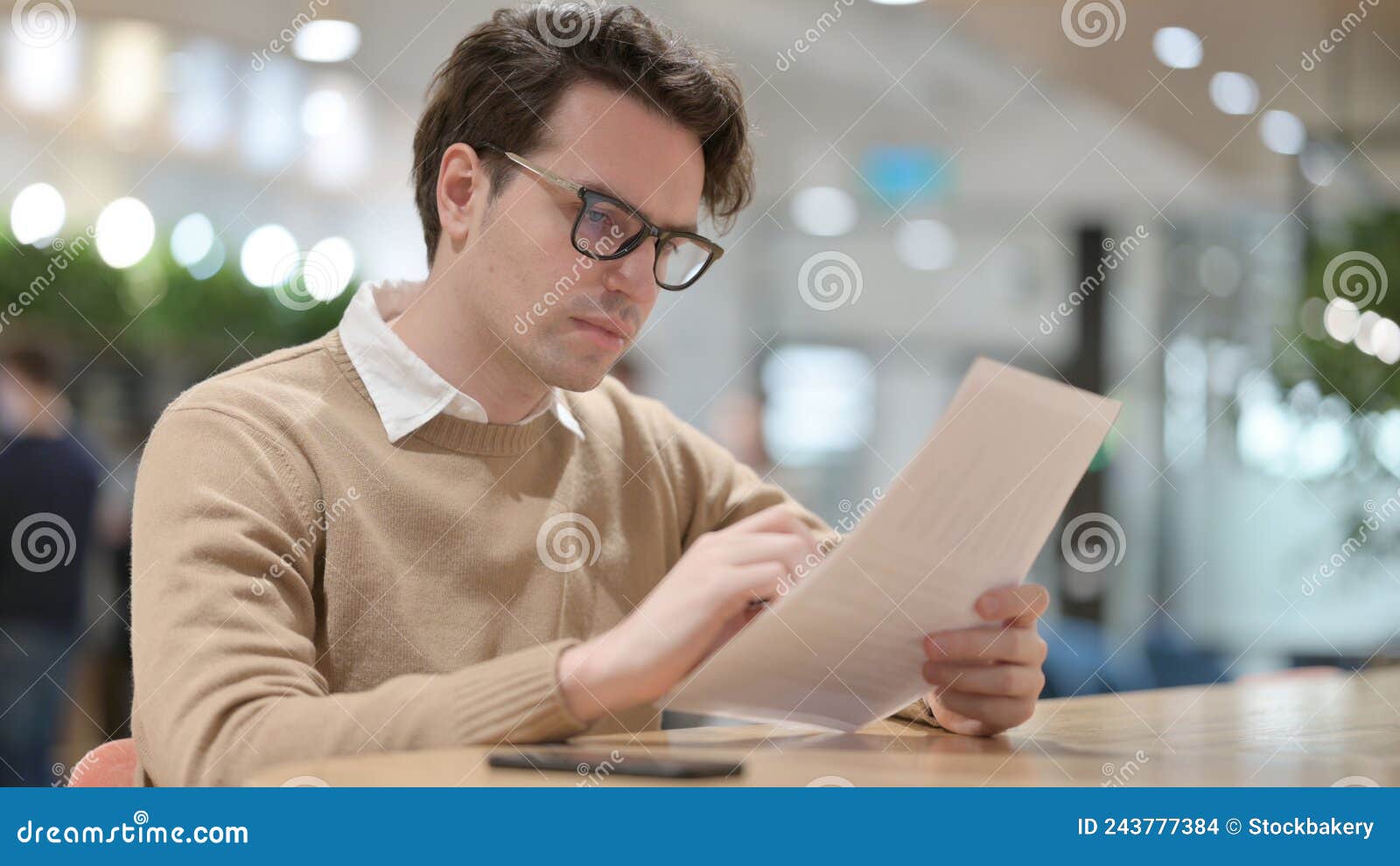 Young Man Reading Documents in Office Stock Photo - Image of review ...