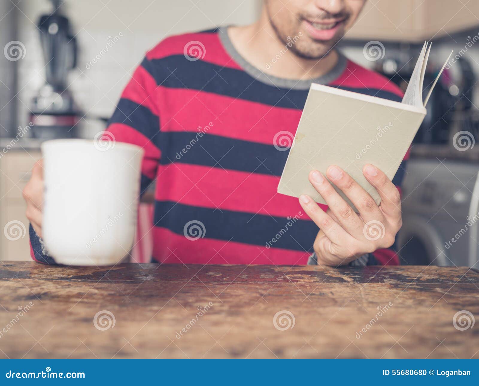 Young Man Reading and Drinking Coffee Stock Photo - Image of student ...