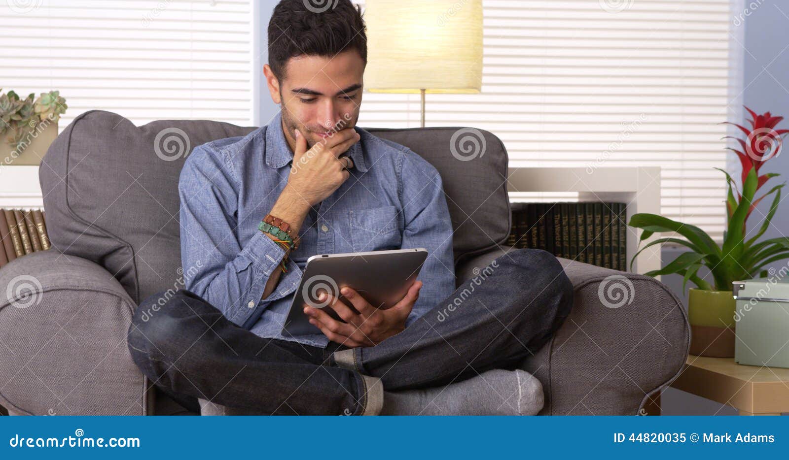 Young Man Reading an E-book on His Tablet Stock Image - Image of mature ...