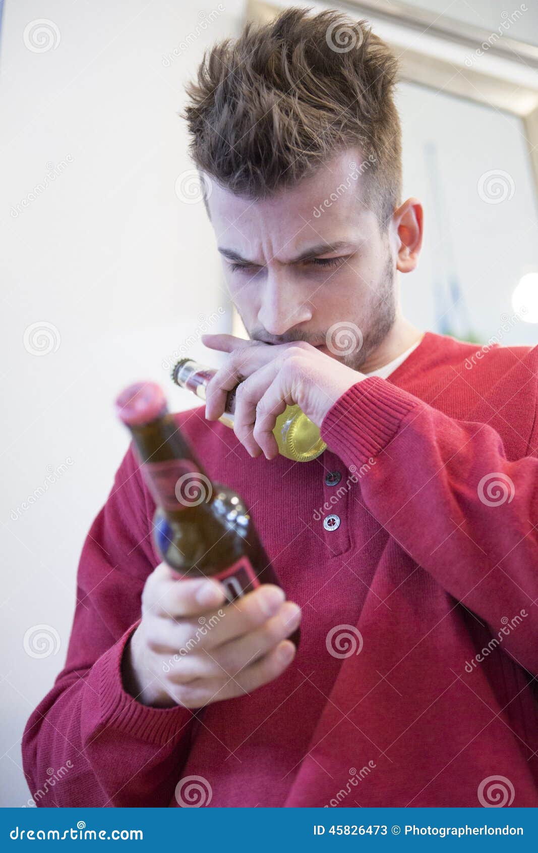 Young Man Reading Label on Beer Bottle in Cafe Stock Image - Image of ...