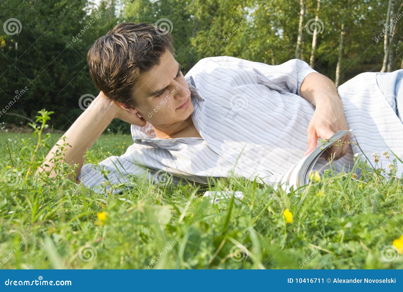 Young Man Reading a Magazine in the Park Stock Image - Image of woods ...