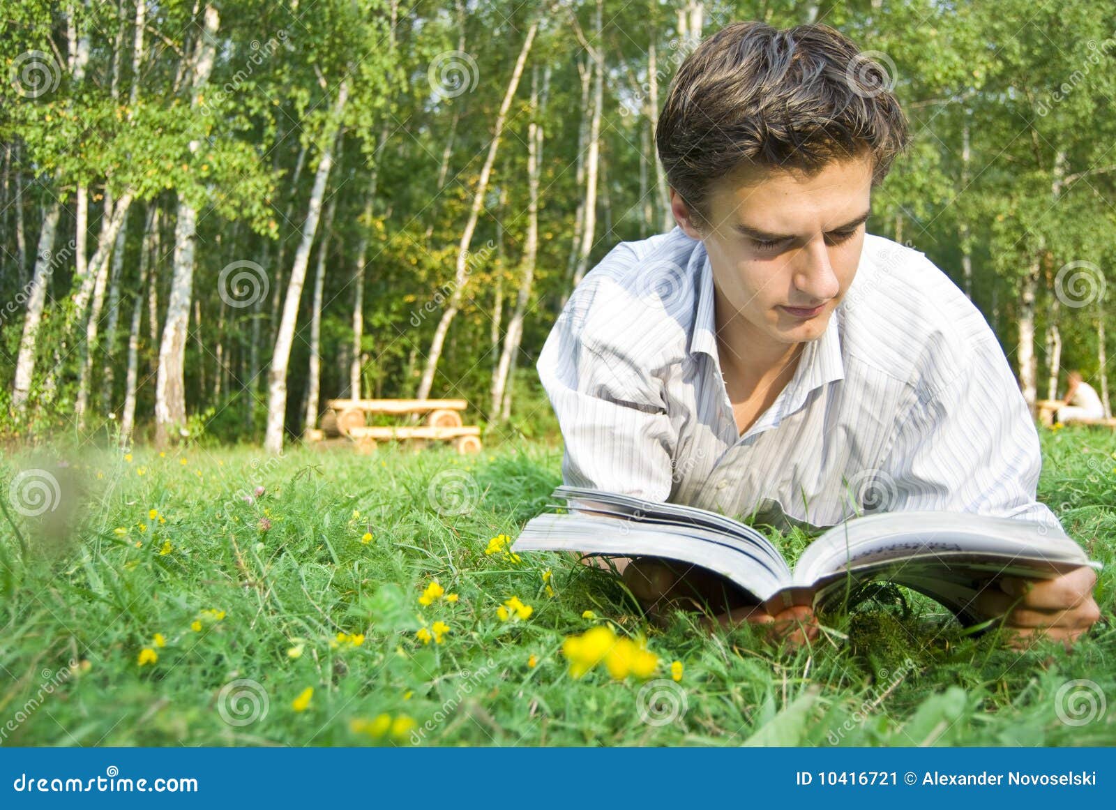 Young Man Reading a Magazine in the Park Stock Image - Image of ...