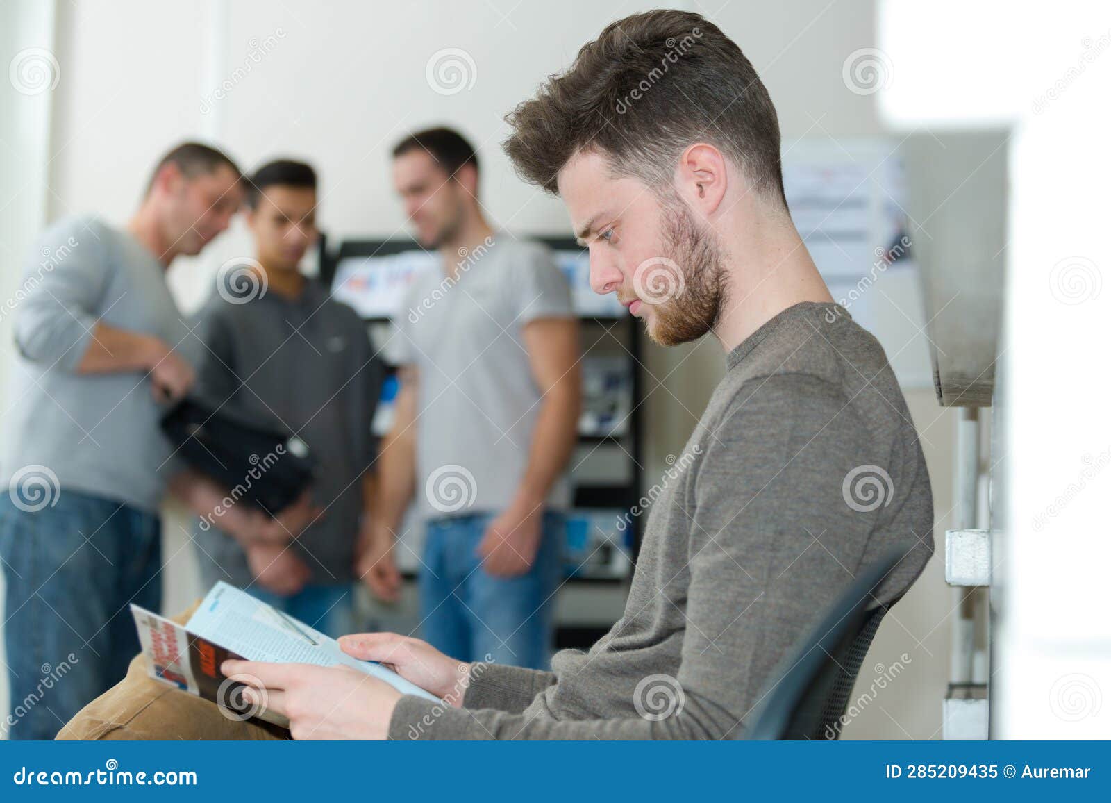 Young Man Reading Magazine in Waiting Room Stock Image - Image of ...
