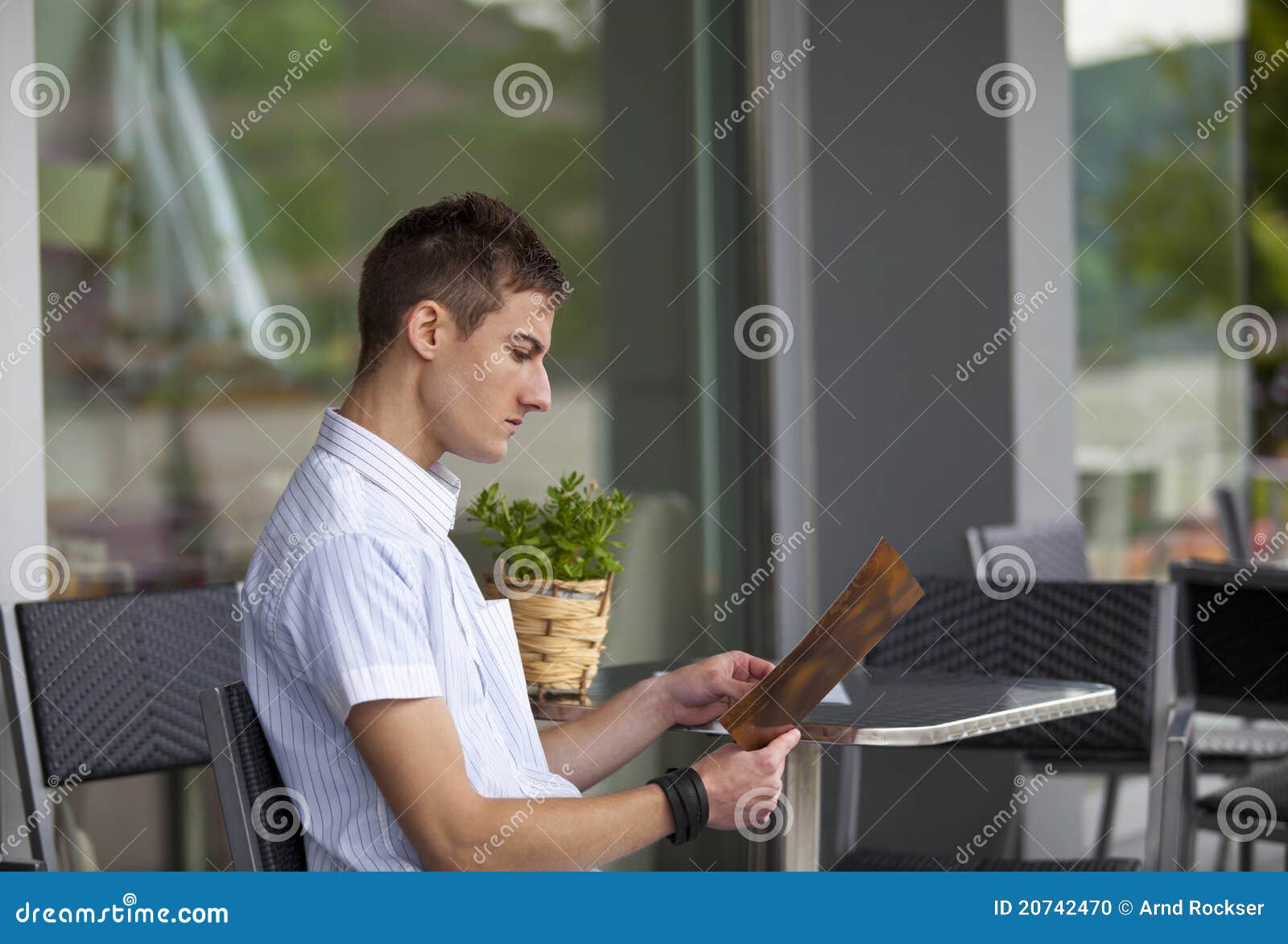Young man reading the menu stock photo. Image of lifestyle - 20742470