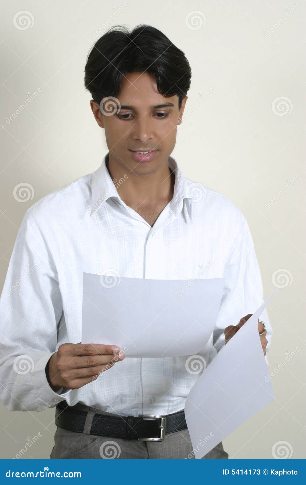 Young man reading papers stock image. Image of indian - 5414173 Young man reading papers stock image. Image of indian - 5414173