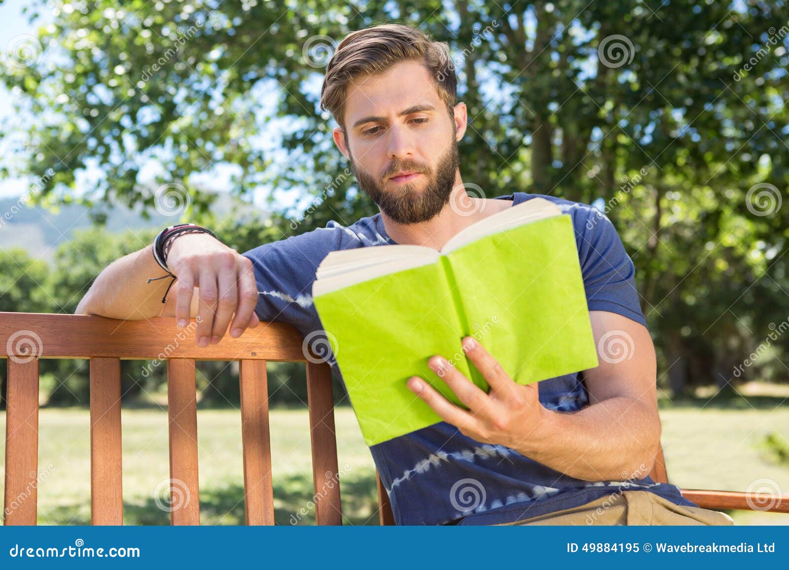 Young Man Reading on Park Bench Stock Image - Image of reading ...