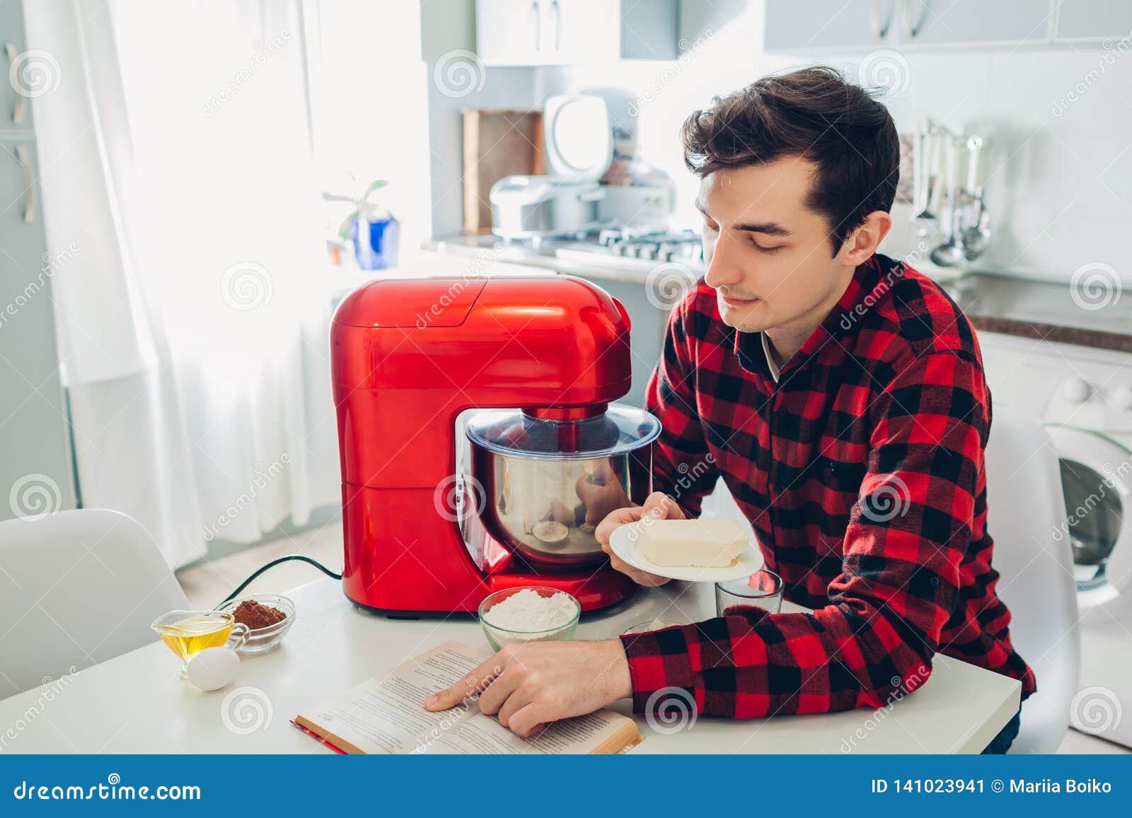 Young Man Reading Recipe in Culinary Book. Guy Cooking Pie with Food ...