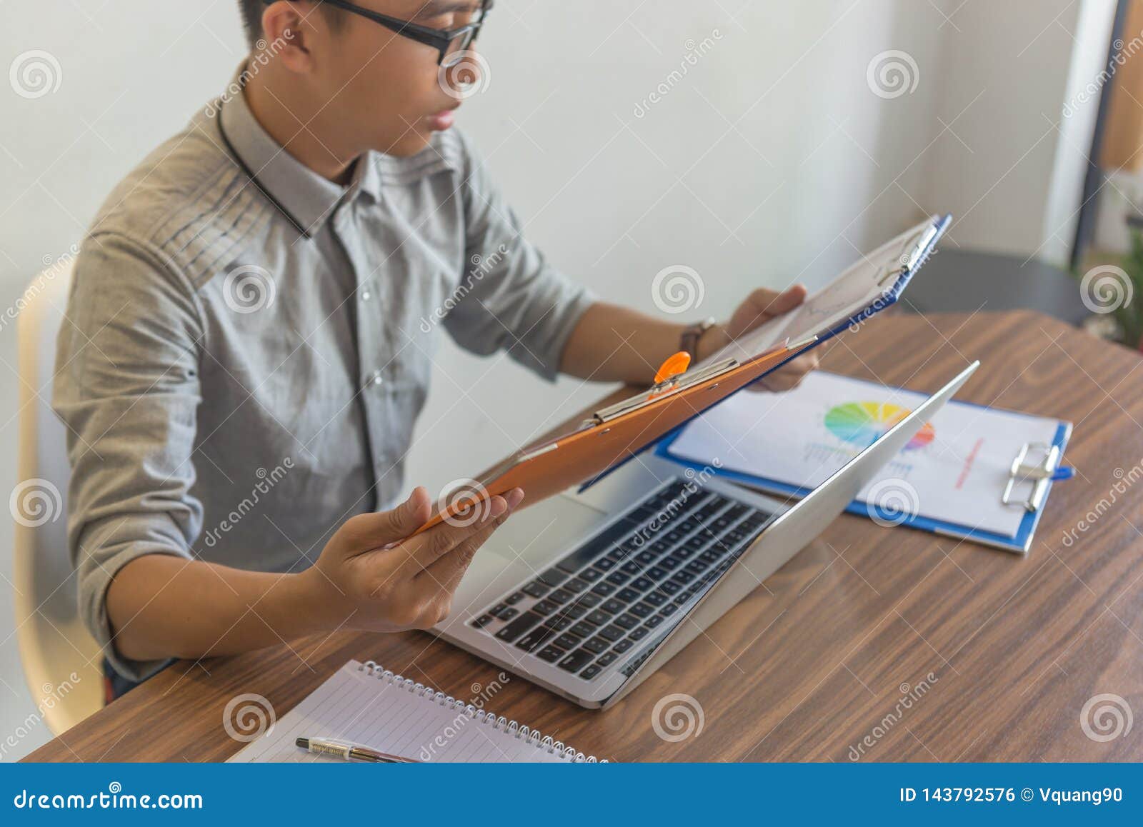 Young Man Reading Report Document at Workplace Stock Photo - Image of ...