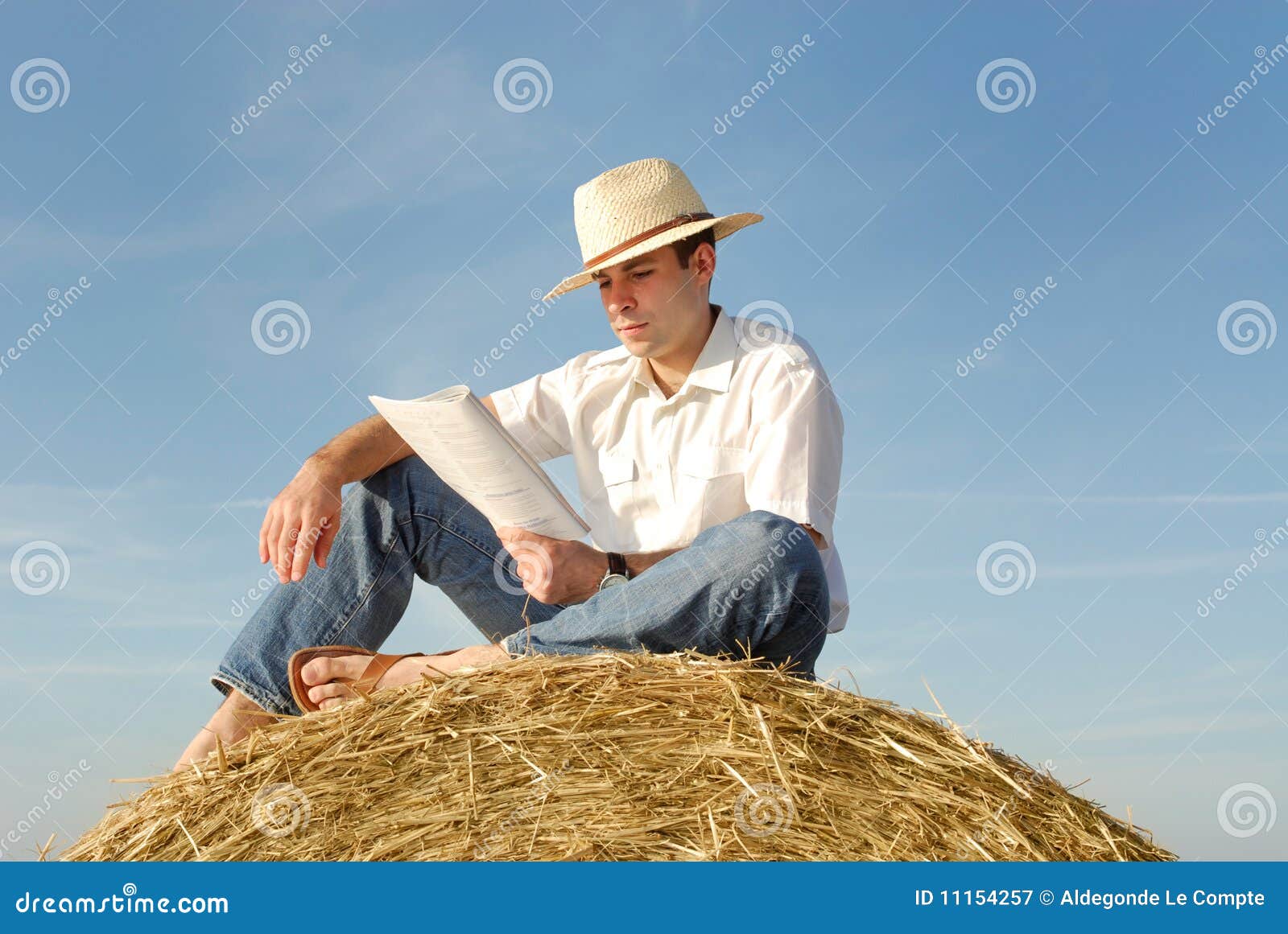 Young Man Reading on Top of a Straw Bale Stock Image - Image of ...