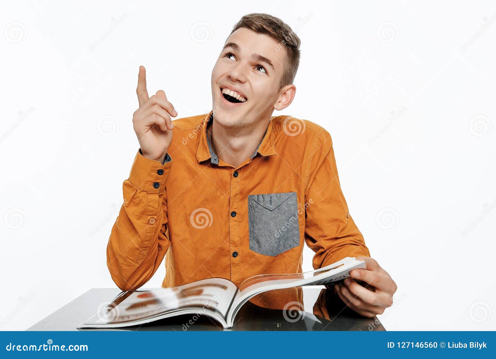 A Young Man Reads a Book. the Guy is Browsing the Magazine. Reading ...