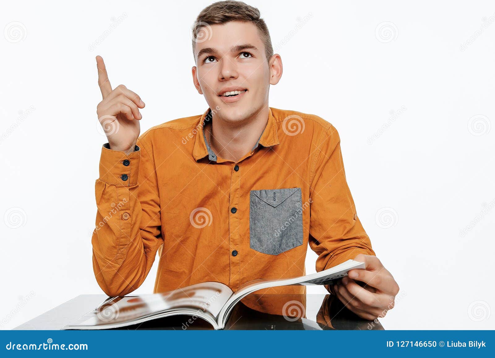 A Young Man Reads a Book. the Guy is Browsing the Magazine. Reading ...