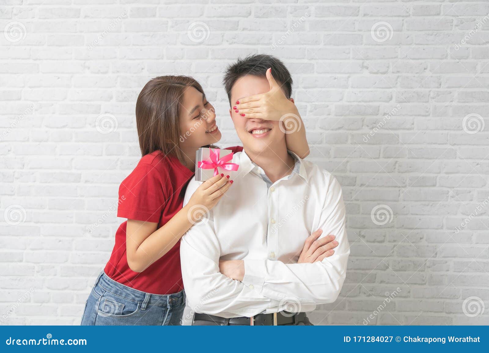 Young Man Receiving a Surprise Gift Box from Girlfriend at Home Stock ...