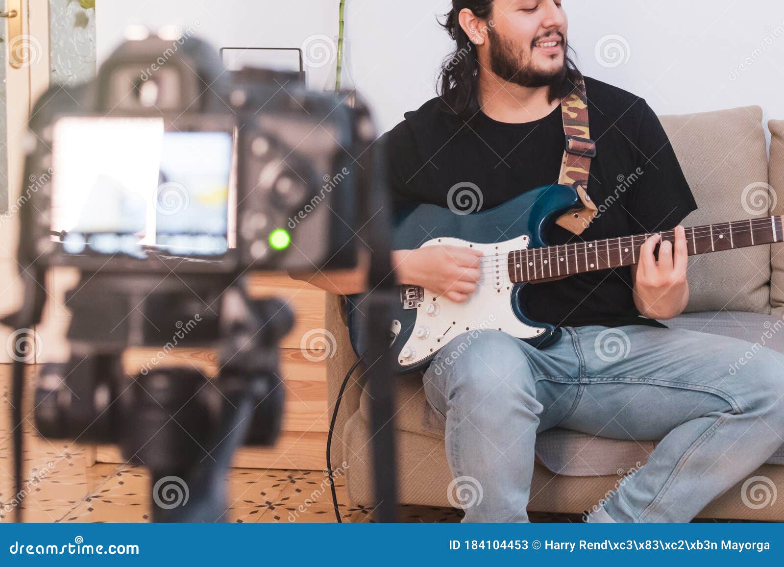 Young Man Recording an Online Guitar Lesson Video Tutorial at Home ...