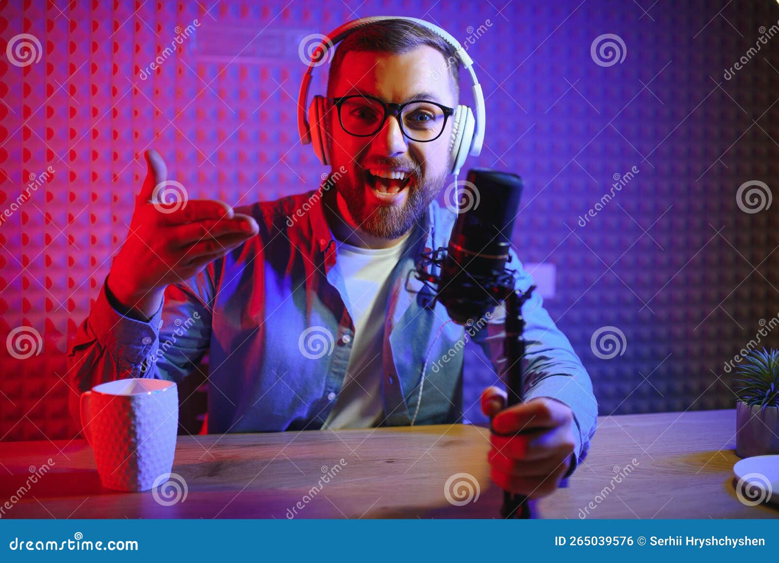 Young Man Recording or Streaming Podcast Using Microphone at His Small ...