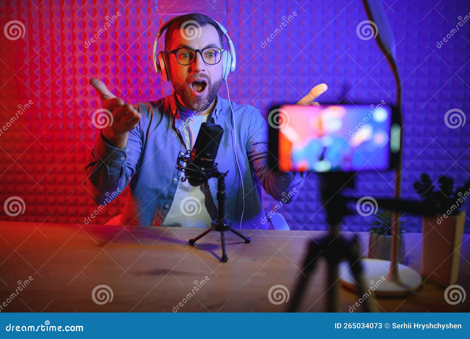 Young Man Recording or Streaming Podcast Using Microphone at His Small ...