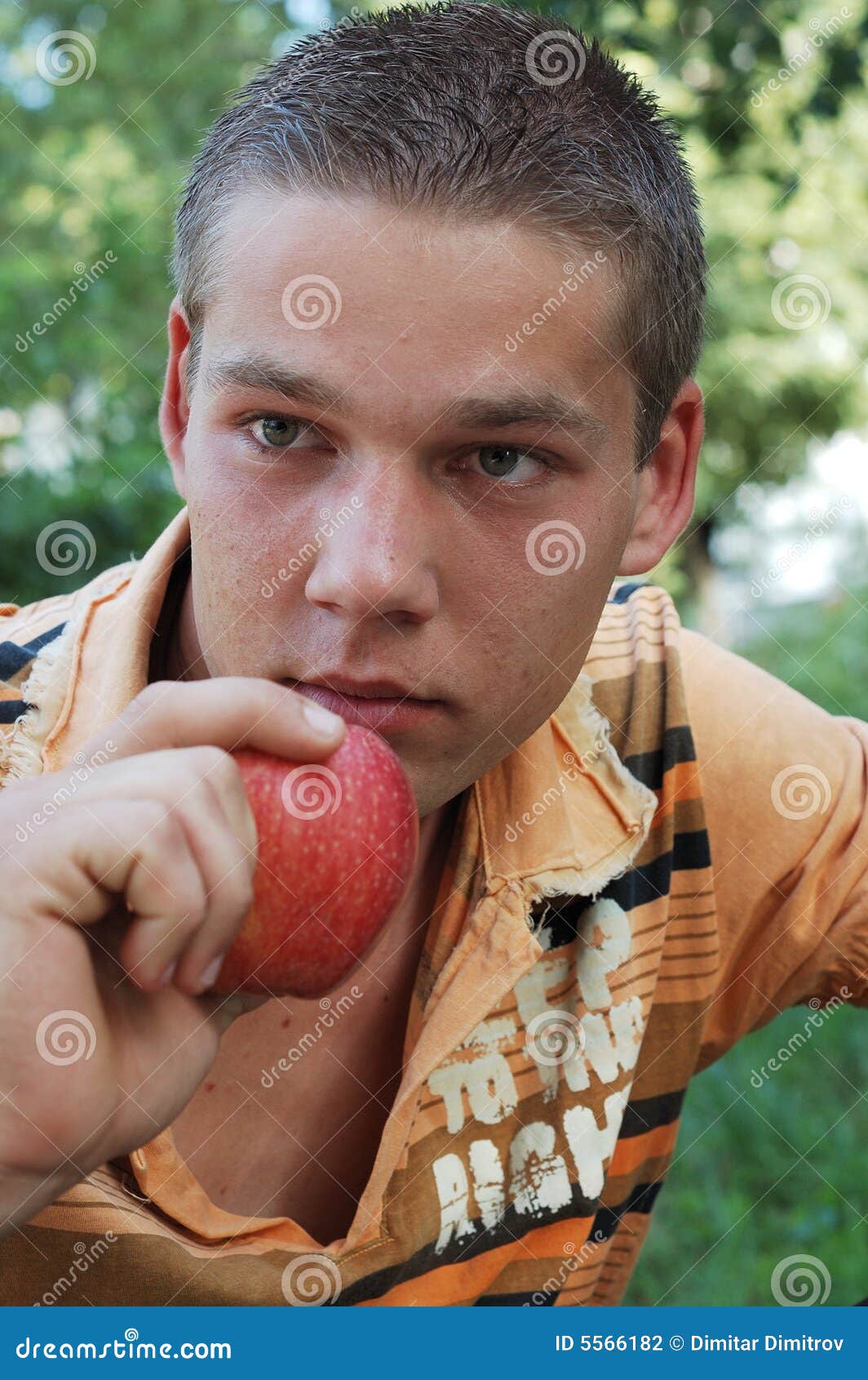 Young man with red apple stock photo. Image of appetizing - 5566182