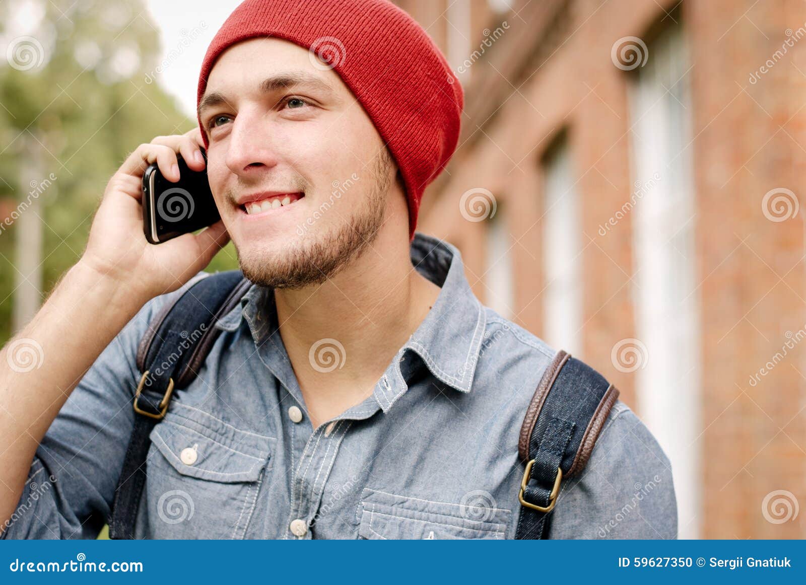 The Young Man with Red Cap Calls on His Cell Phone Stock Photo - Image ...
