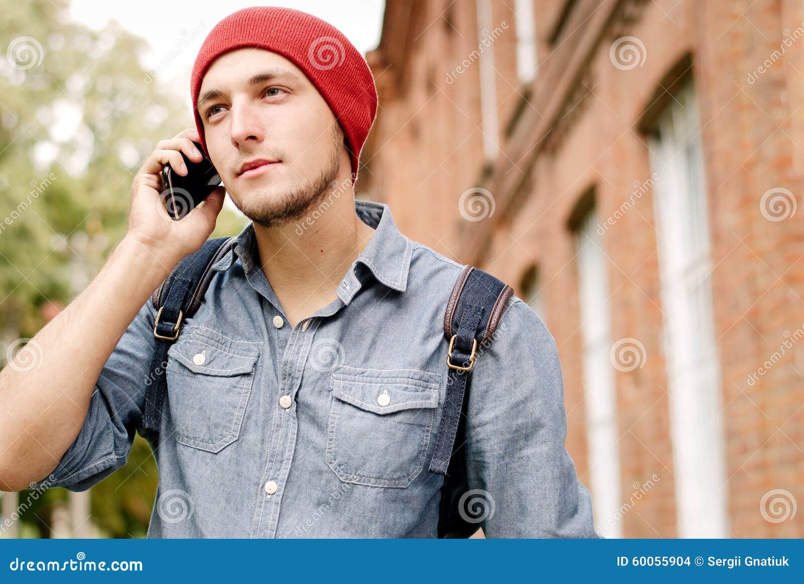 The Young Man with Red Cap Calls on His Cell Phone Stock Photo - Image ...