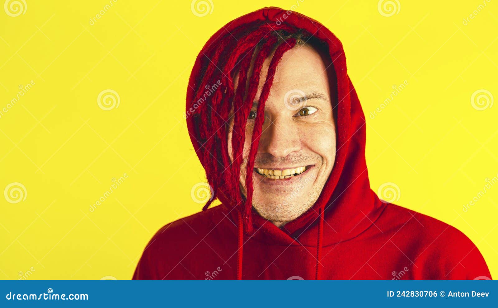 Young Man with Red Dreadlocks in Hood Grimacing Face. Crazy Guy Aping ...