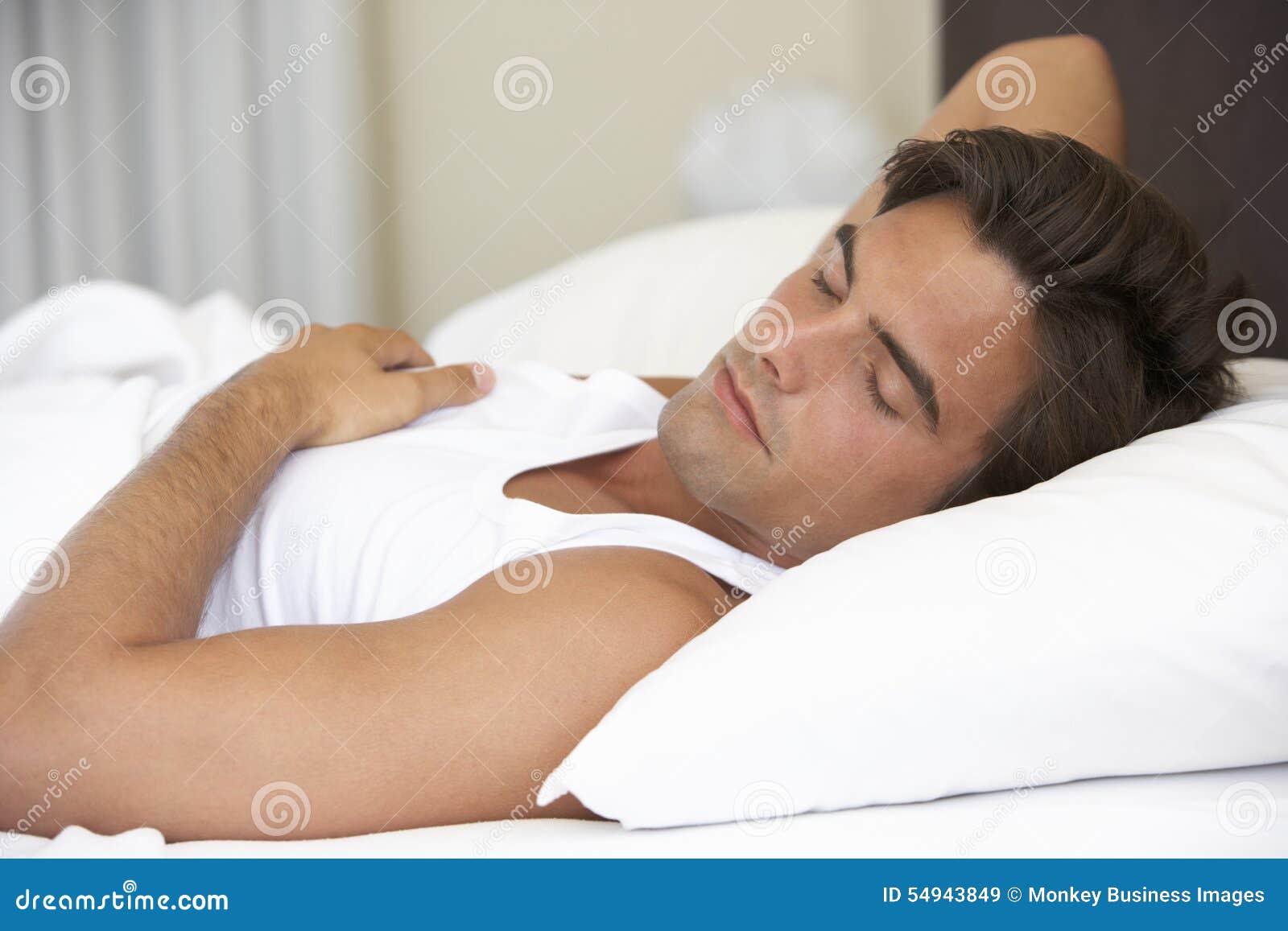 Young Man Relaxing on Bed stock image. Image of sleep - 54943849