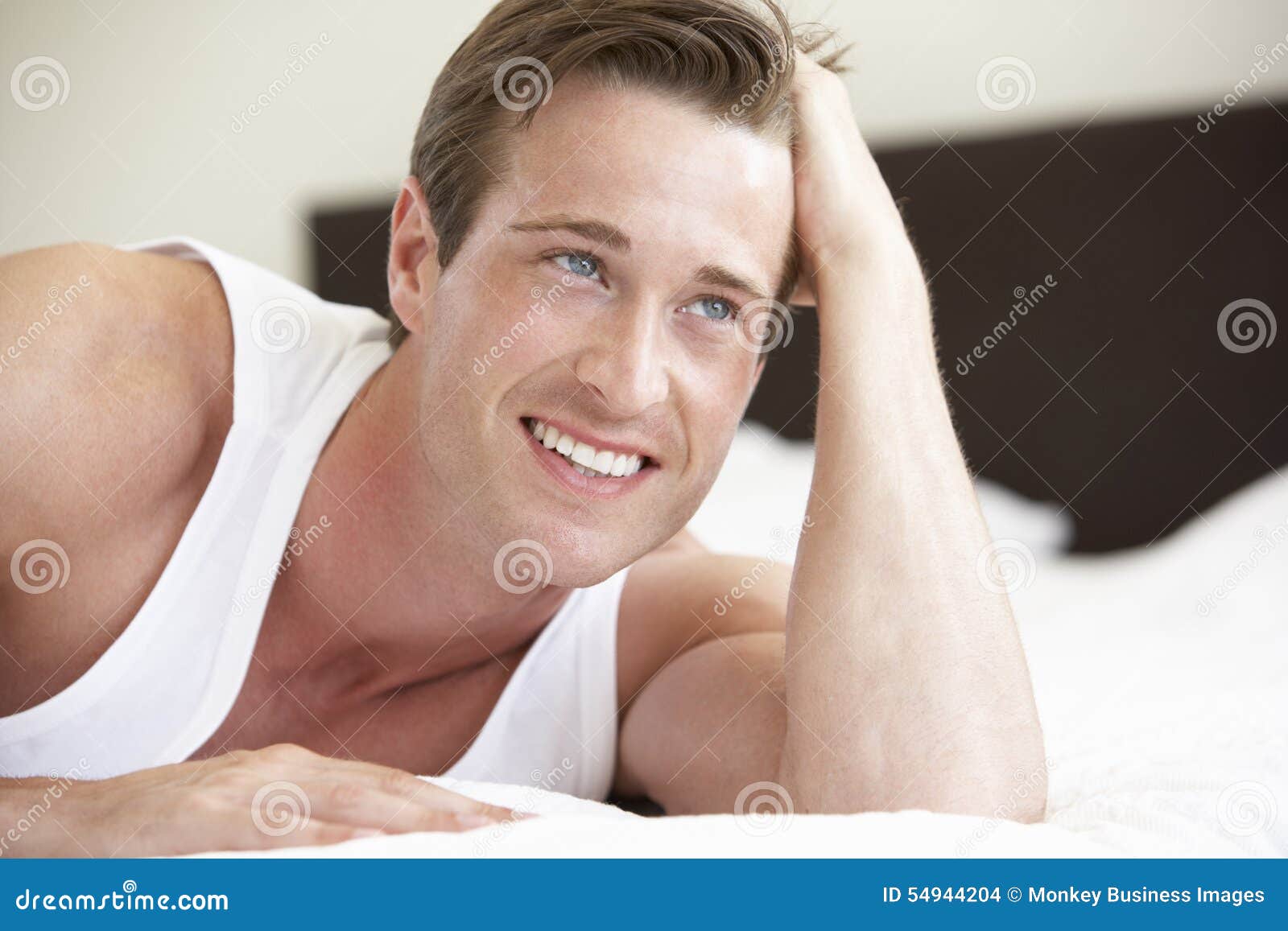 Young Man Relaxing on Bed stock photo. Image of blond - 54944204