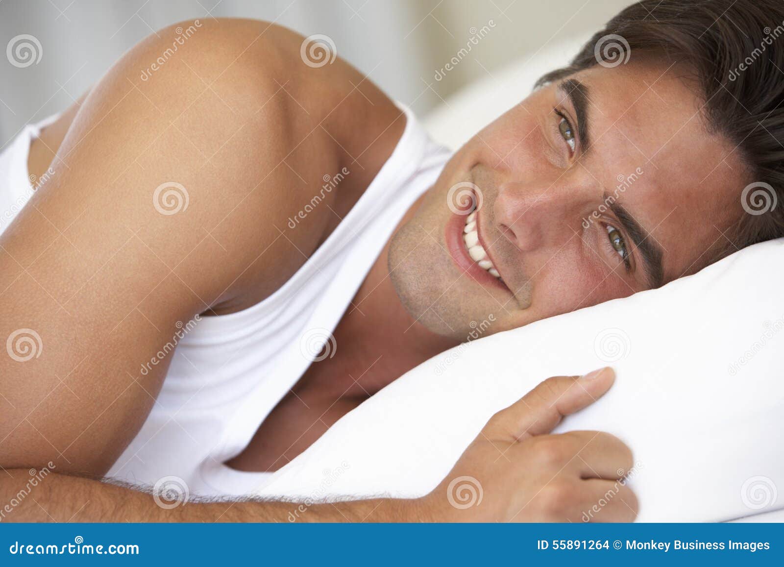 Young Man Relaxing on Bed stock photo. Image of twenties - 55891264