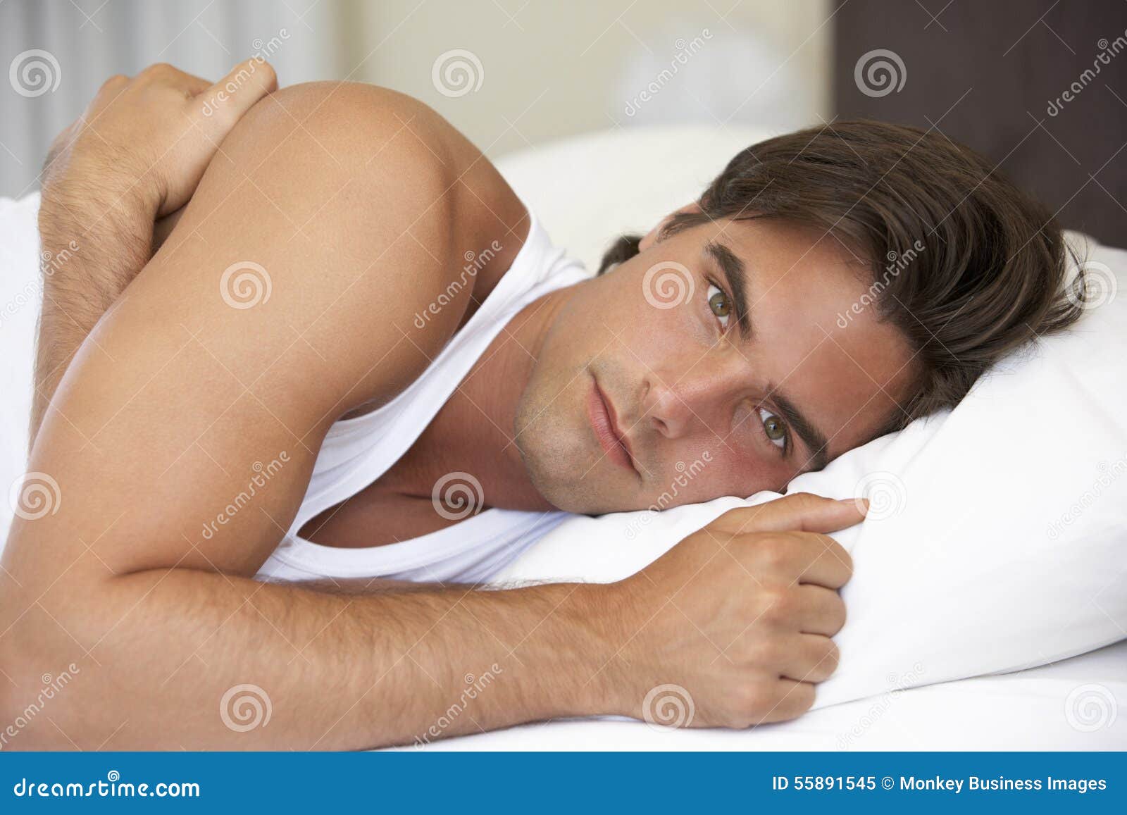Young Man Relaxing on Bed stock image. Image of caucasian - 55891545