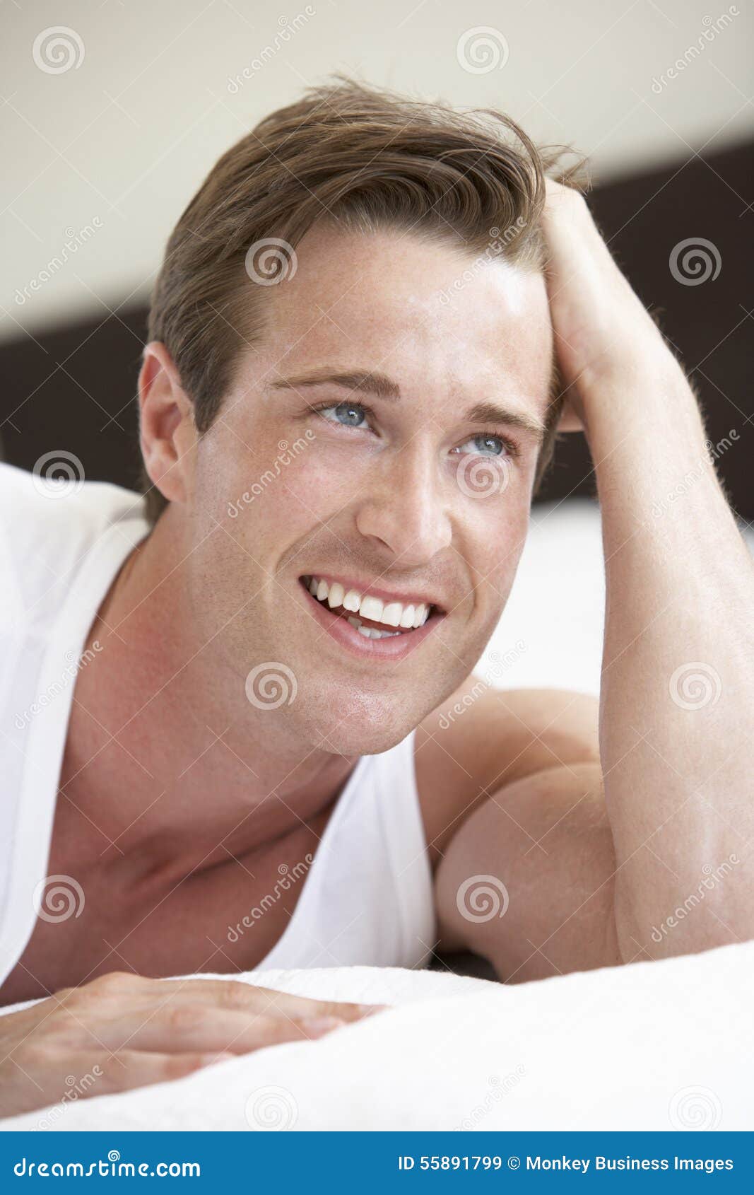 Young Man Relaxing on Bed stock image. Image of handsome - 55891799