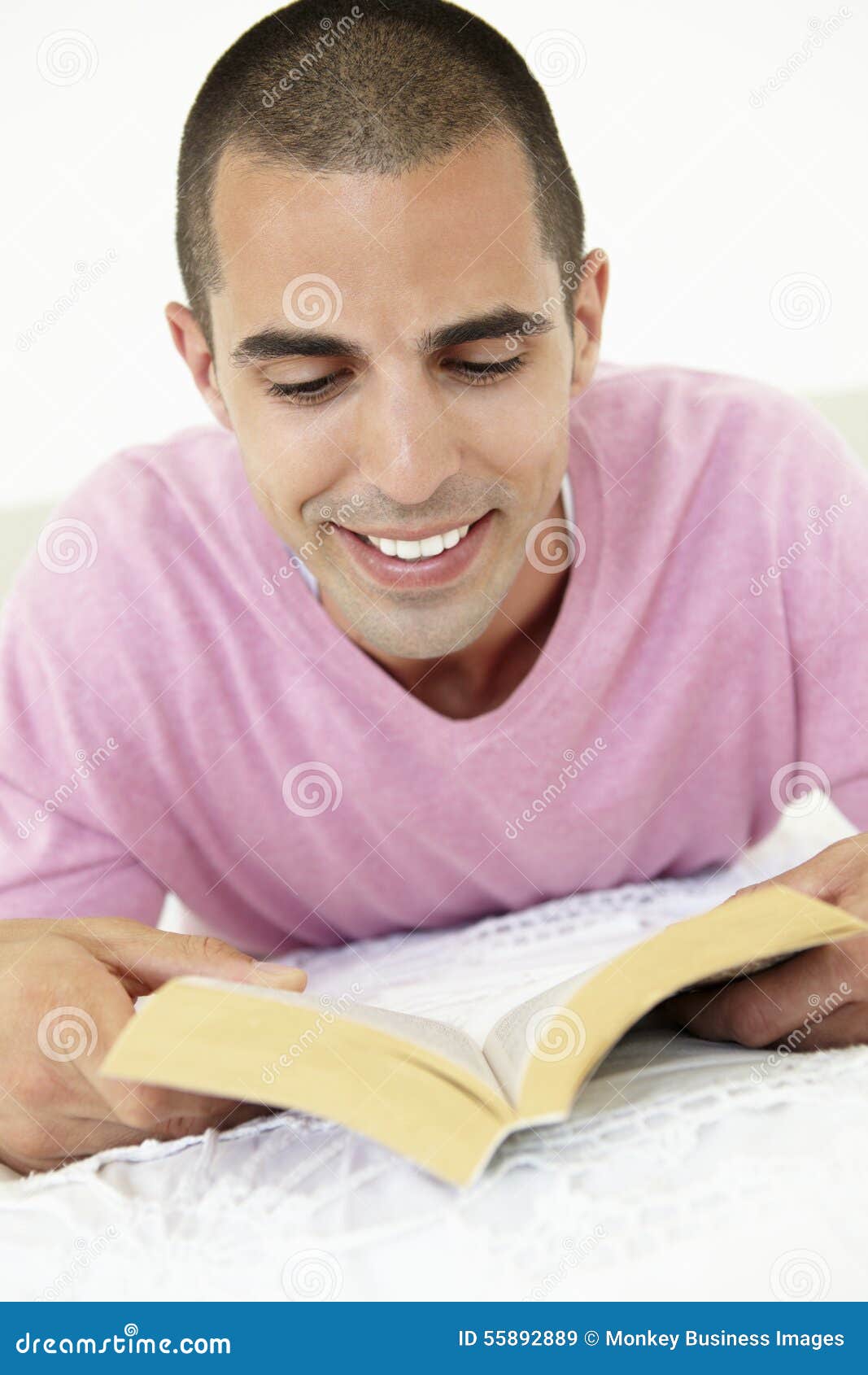 Young Man Relaxing on Bed Reading Book Stock Image - Image of relaxed ...
