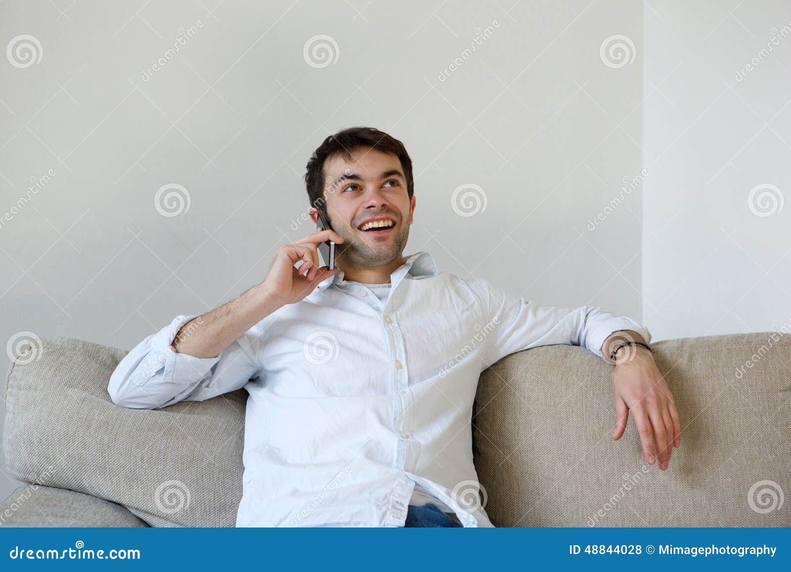 Young Man Relaxing at Home Calling by Mobile Phone Stock Photo - Image ...
