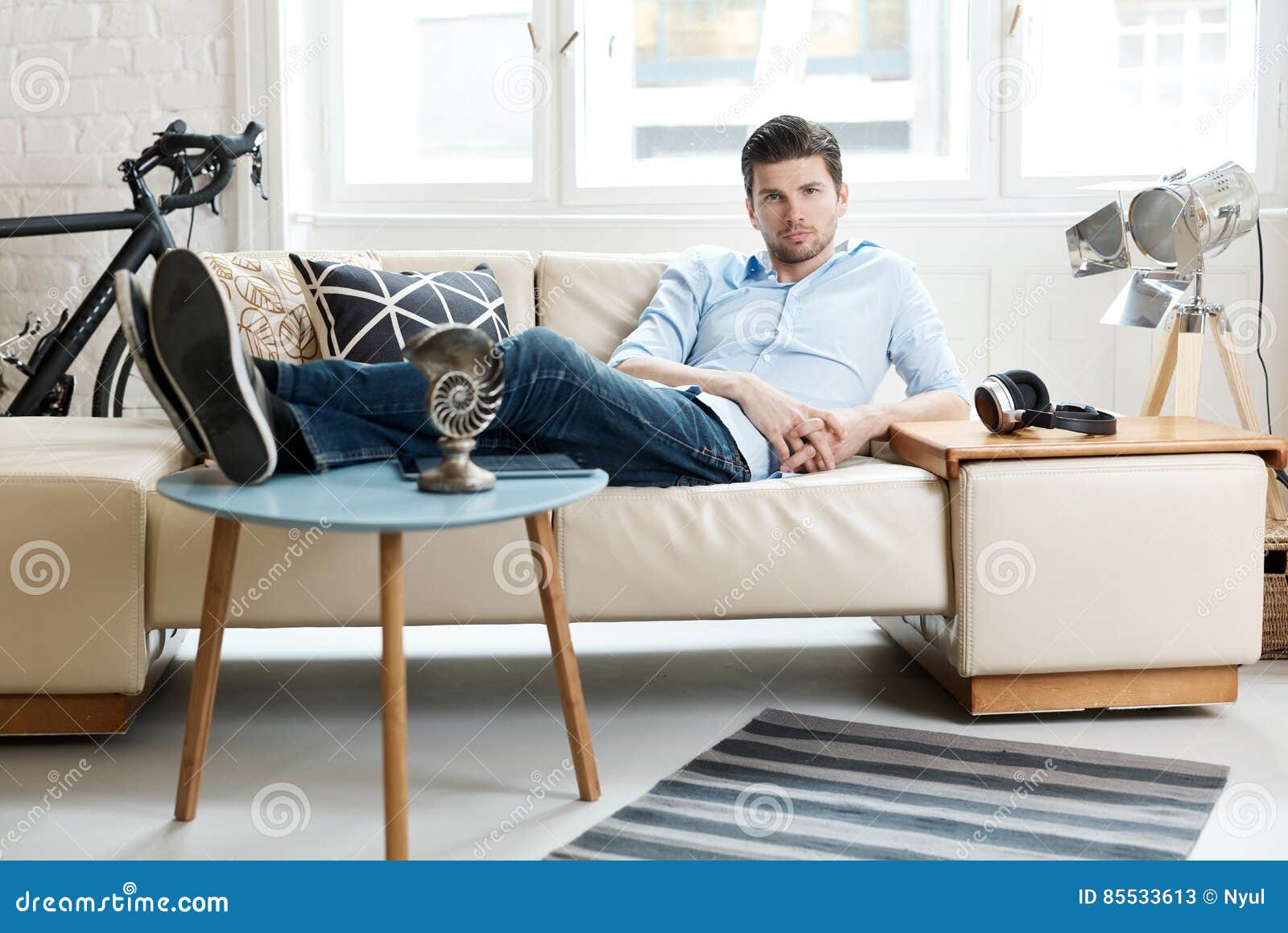 Young man relaxing at home stock image. Image of clothes - 85533613