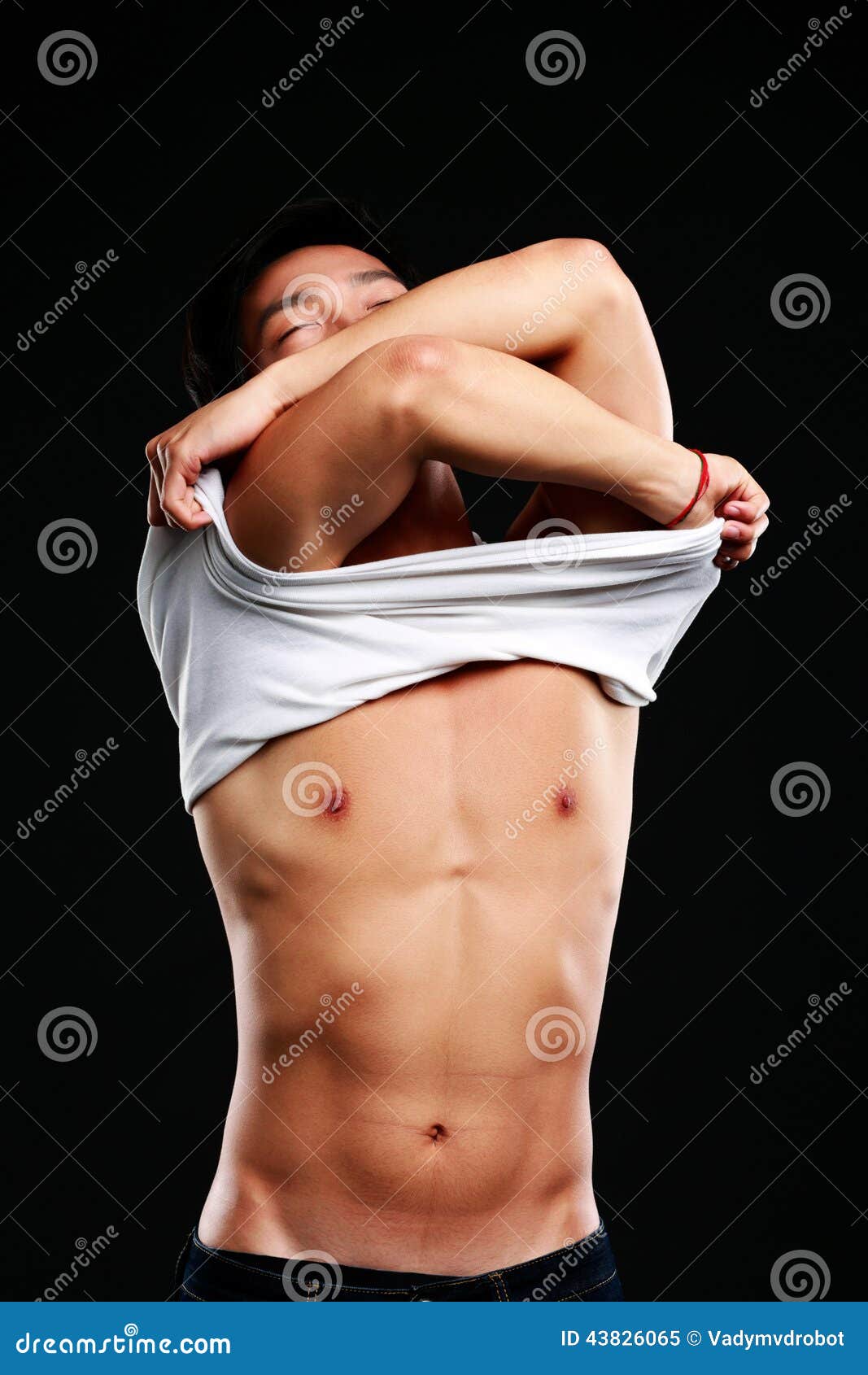 Young Man Removing His T-shirt Stock Image - Image of male, fashion ...