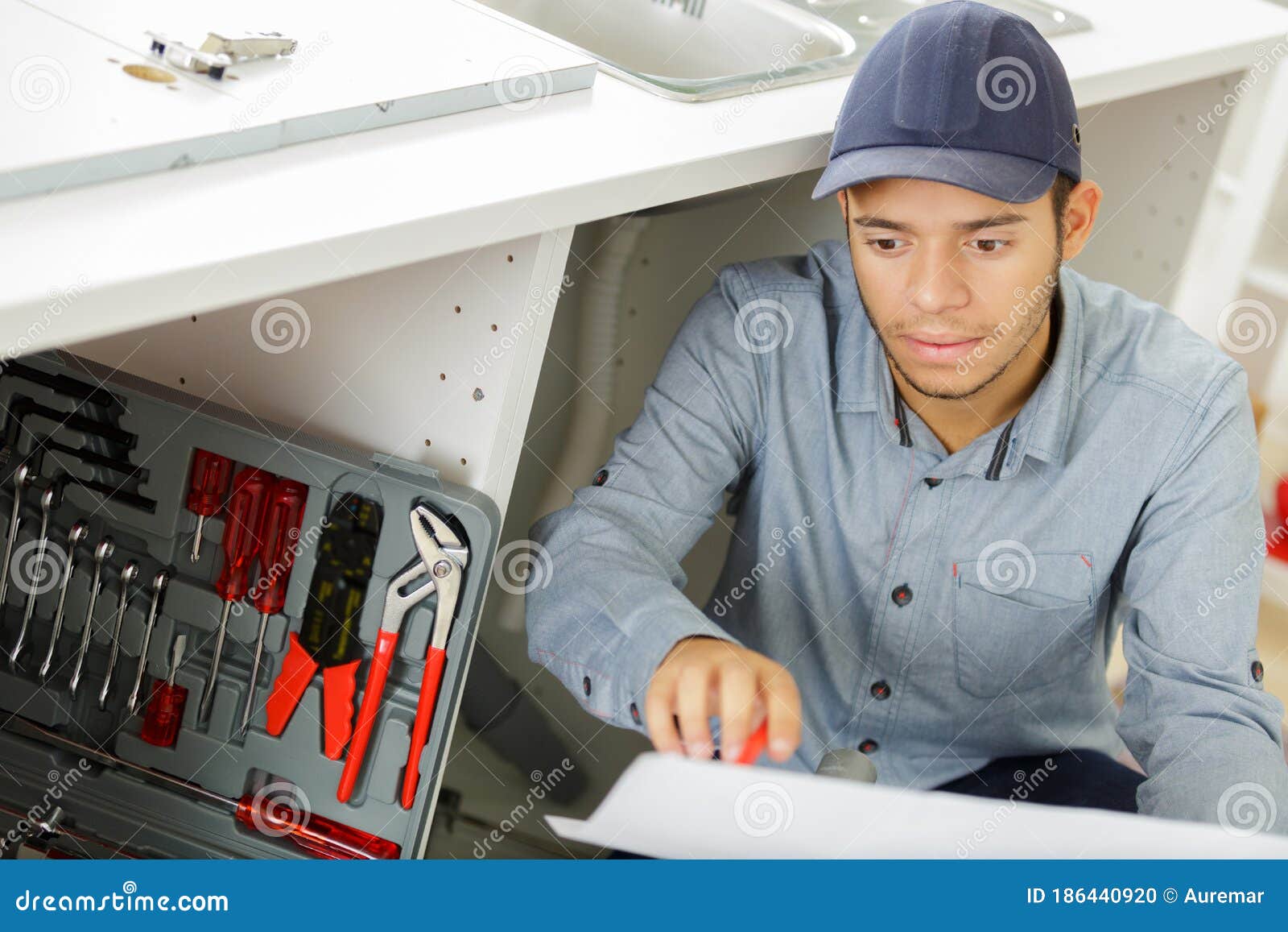 Young Man Repair Something Inside Kitchen Cabinet Under Sink Stock ...