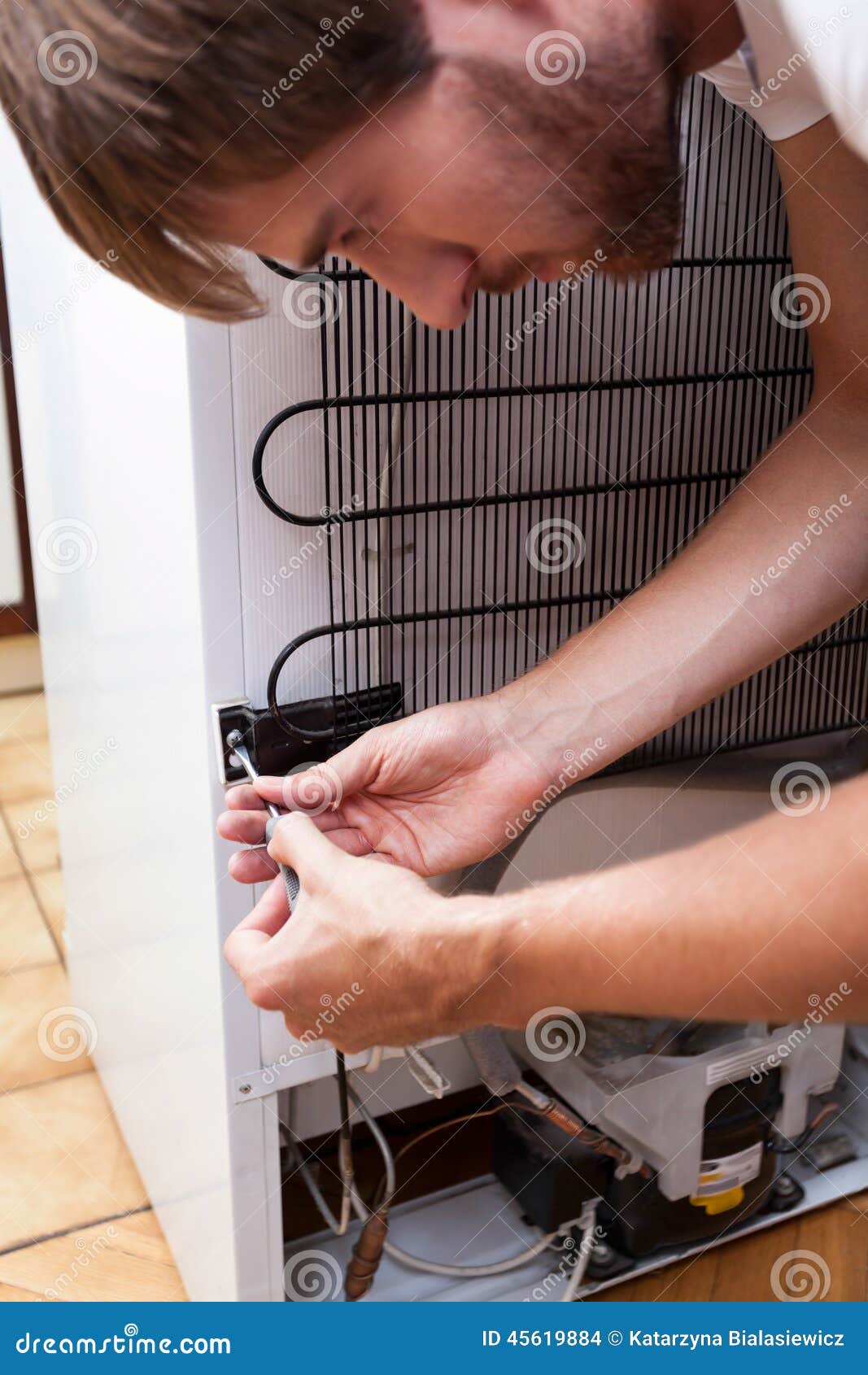 Young man repairing fridge stock photo. Image of fixing - 45619884