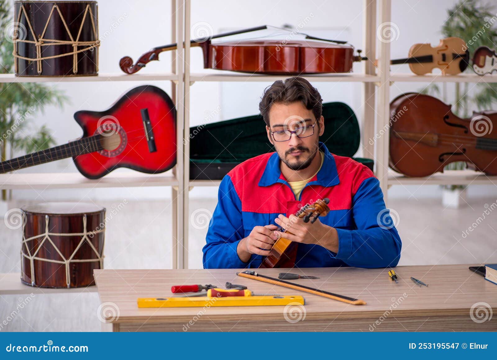Young Man Repairing Musical Instruments at Workshop Stock Image - Image ...