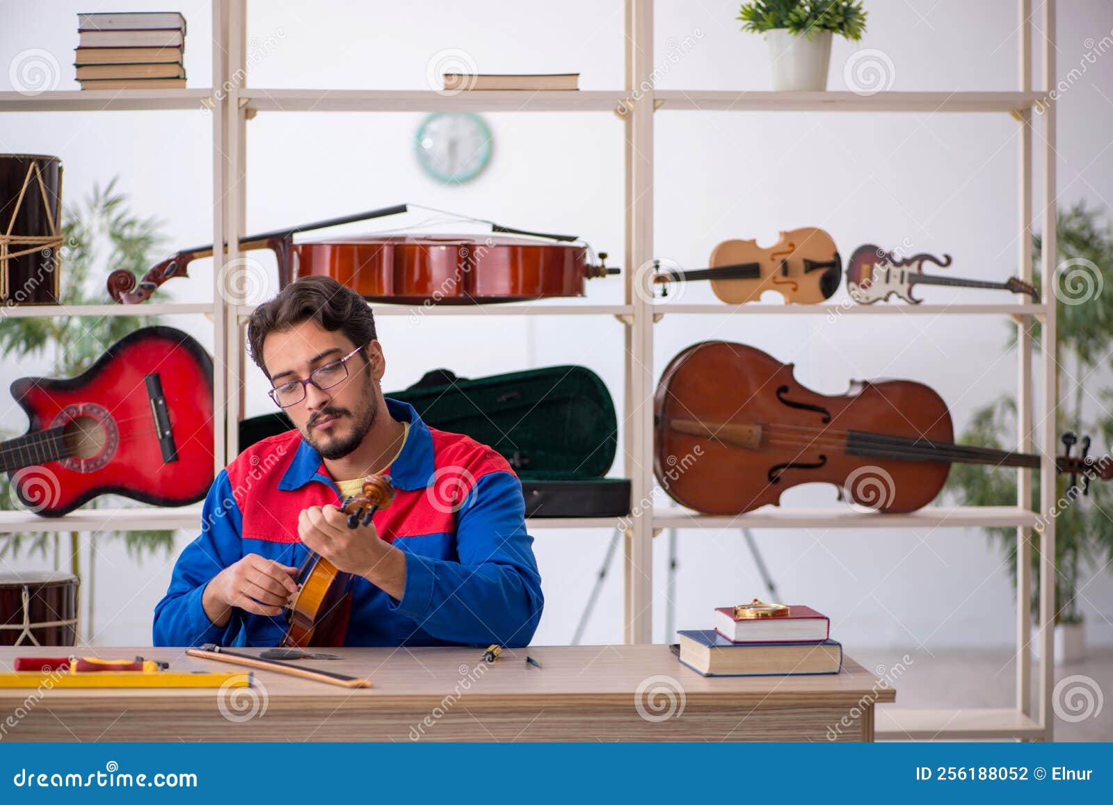 Young Man Repairing Musical Instruments at Workshop Stock Photo - Image ...
