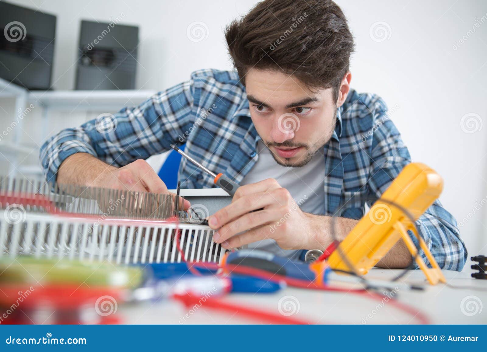 Young Man Repairing Radiator Stock Photo - Image of repairing, handyman ...