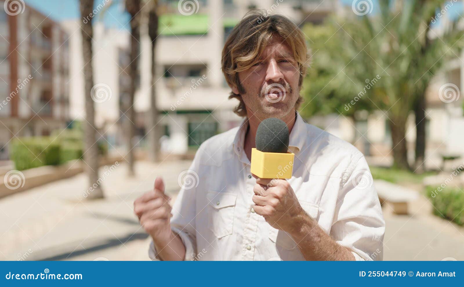 Young Man Reporter Working Using Microphone at Park Stock Video - Video ...