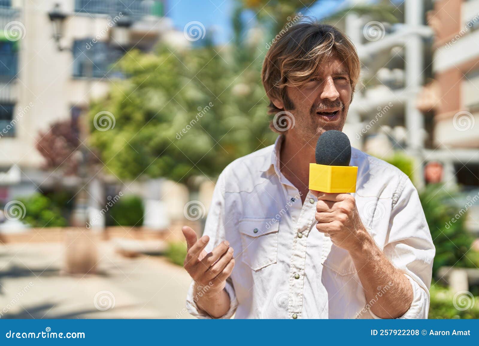 Young Man Reporter Working Using Microphone at Park Stock Photo - Image ...