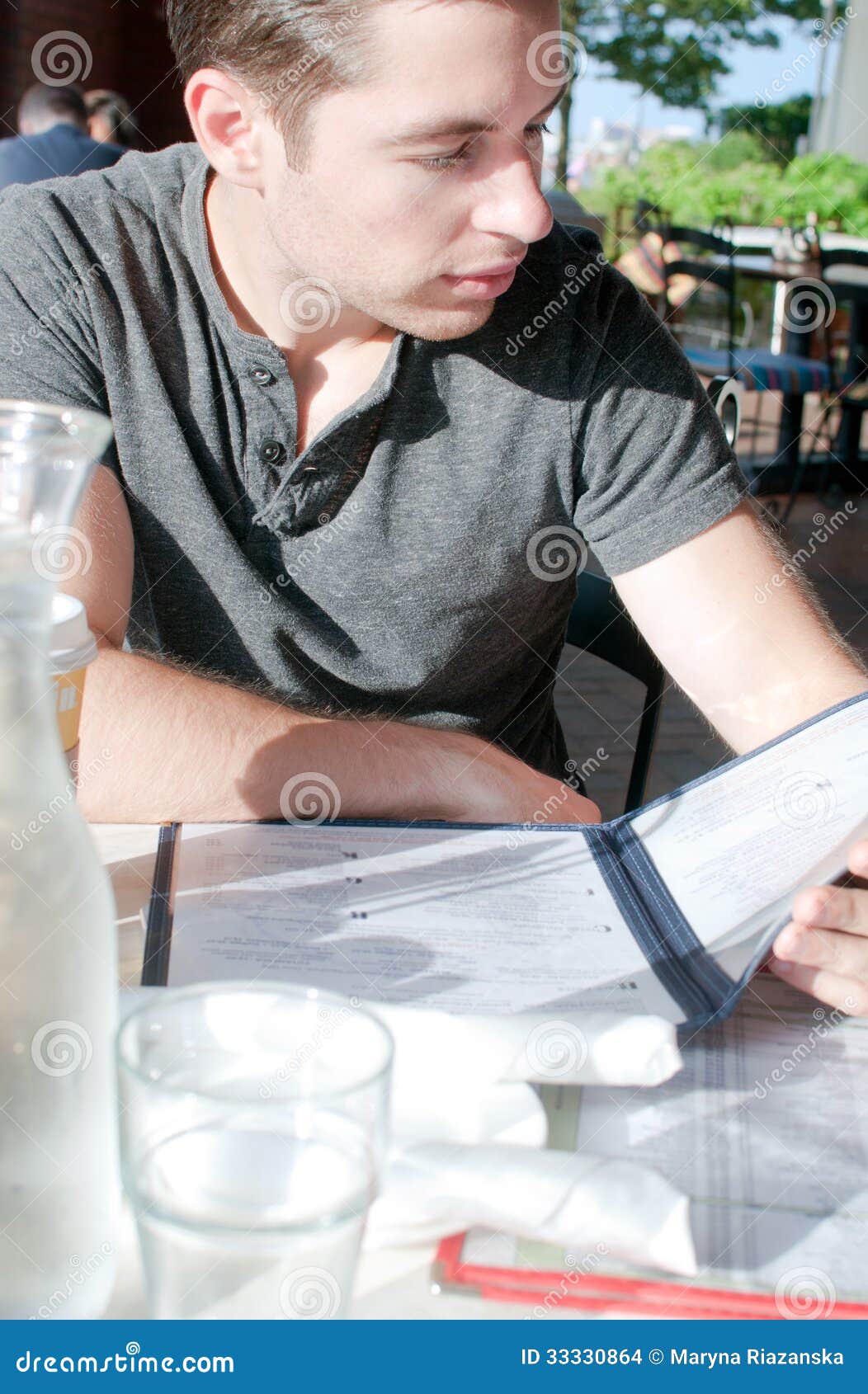 Young Man in Restaurant Reading Menu Stock Photo - Image of bistro ...