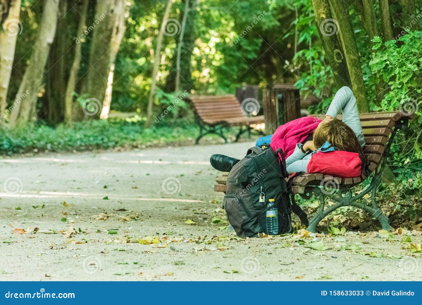 Young Man Resting on Bench with Backpack on the Floor Editorial Stock ...