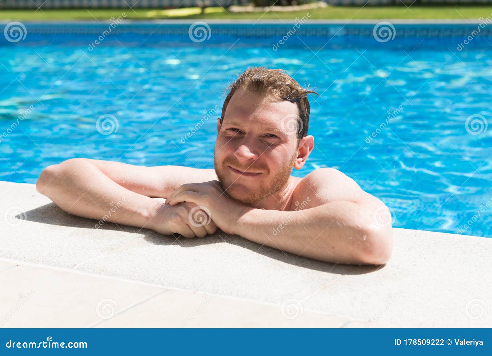 Young Man Resting on Edge of Swimming Pool Stock Photo - Image of hair ...