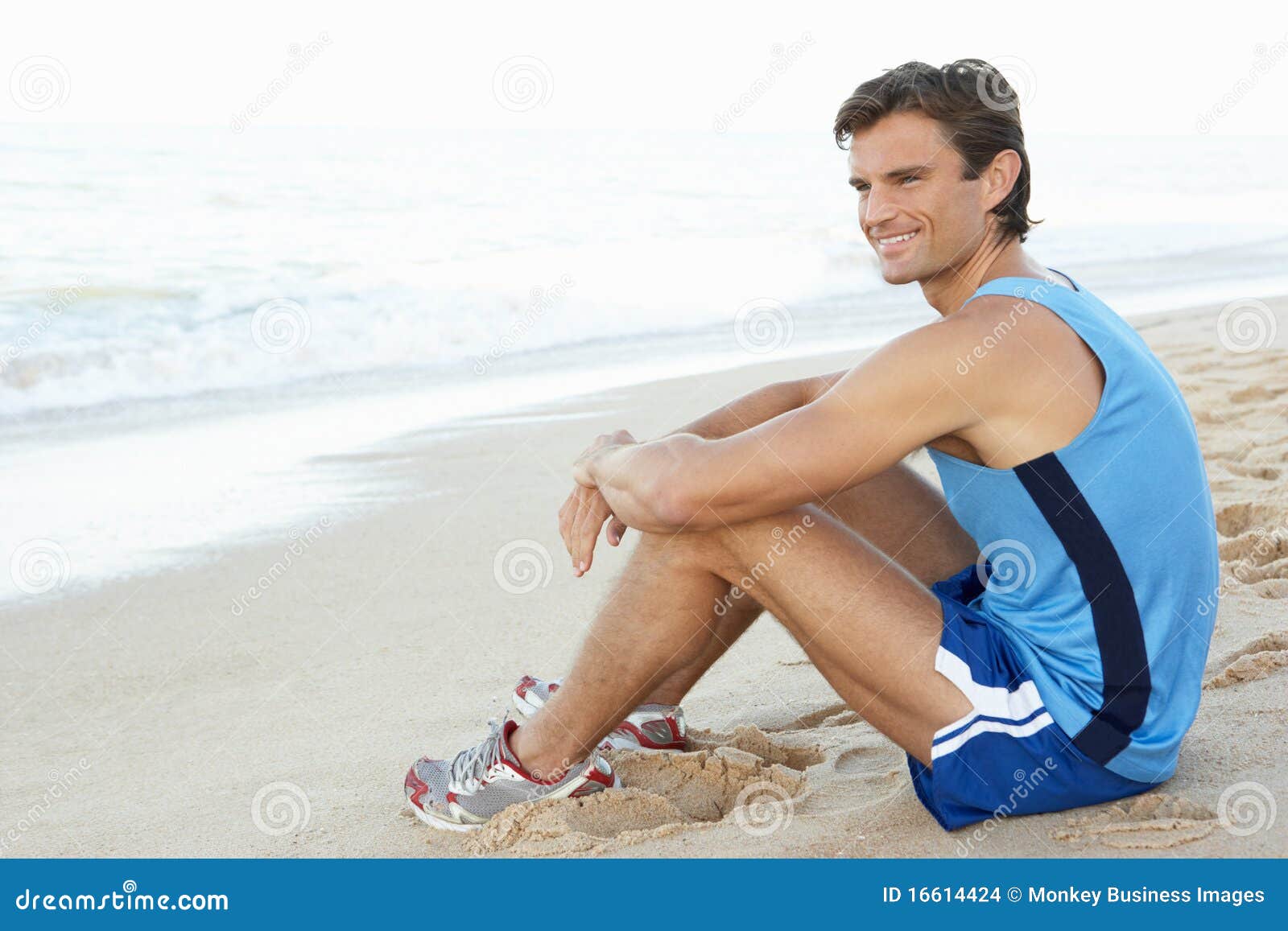 Young Man Resting after Exercise on Beach Stock Photo - Image of ...