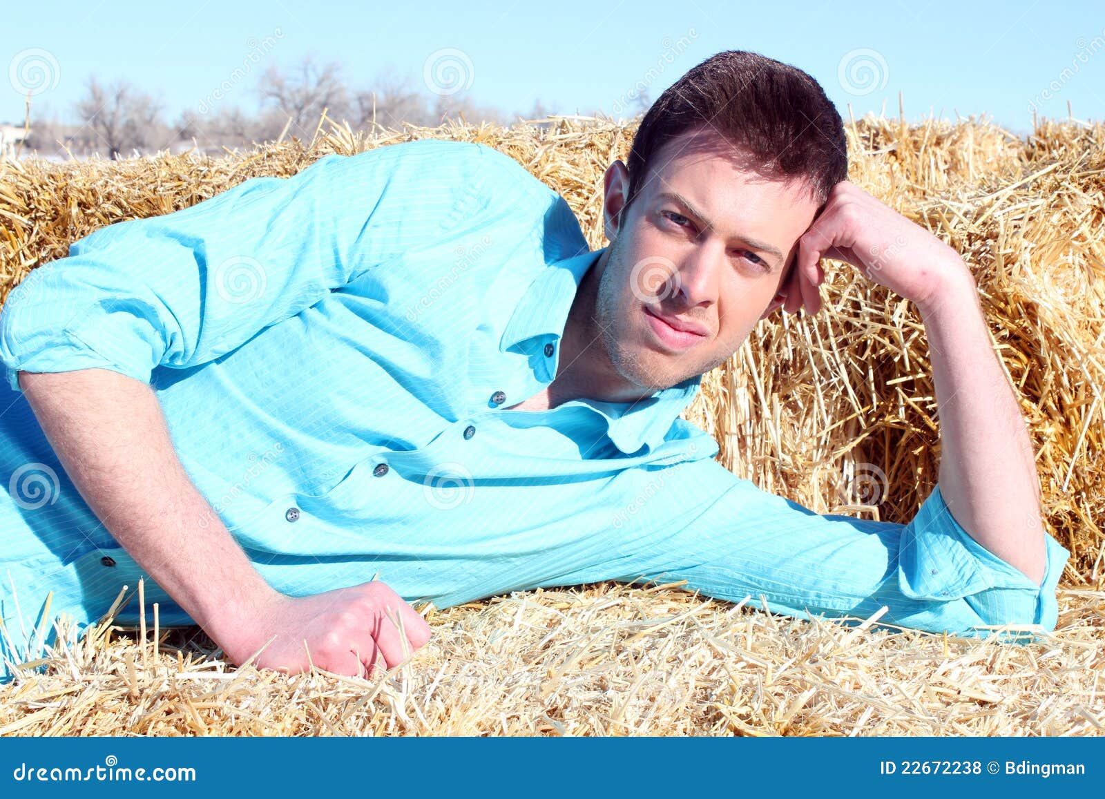 Young Man Resting on Hay Bales Stock Photo - Image of male, portrait ...