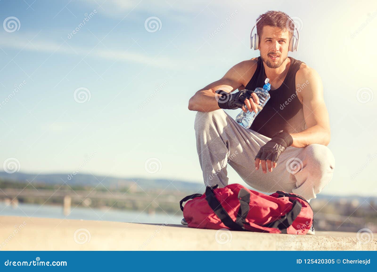 Young Man Resting Next River after Workout Stock Image - Image of ...