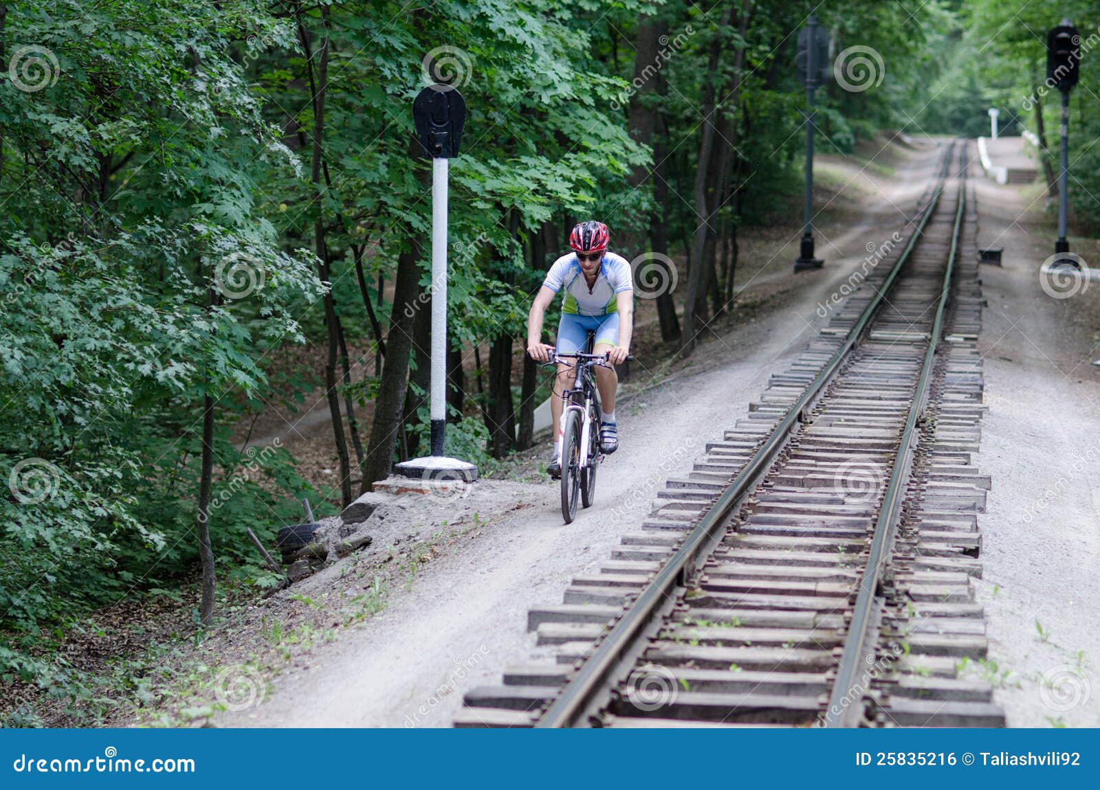 Young Man Rides in the Forest Near the Railroad Stock Photo - Image of ...