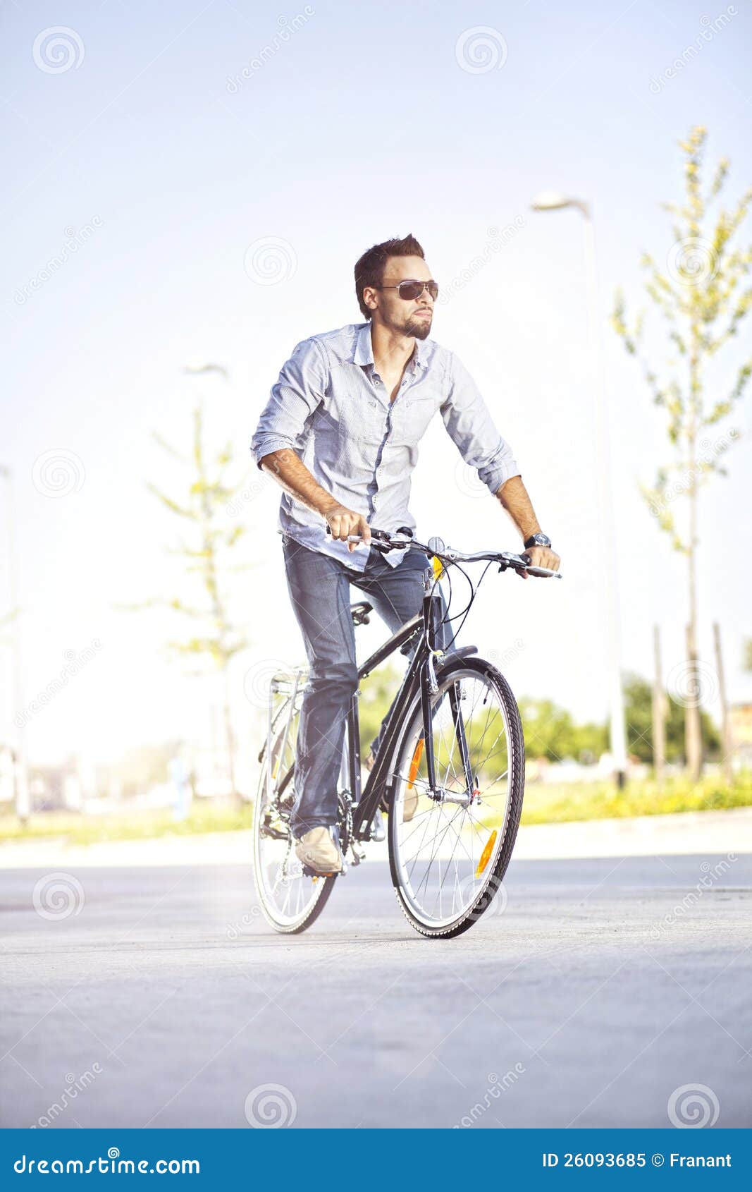 Young man riding a bicycle stock image. Image of action - 26093685