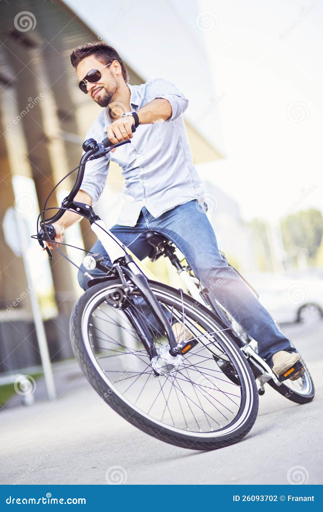 Young man riding a bicycle stock photo. Image of male - 26093702