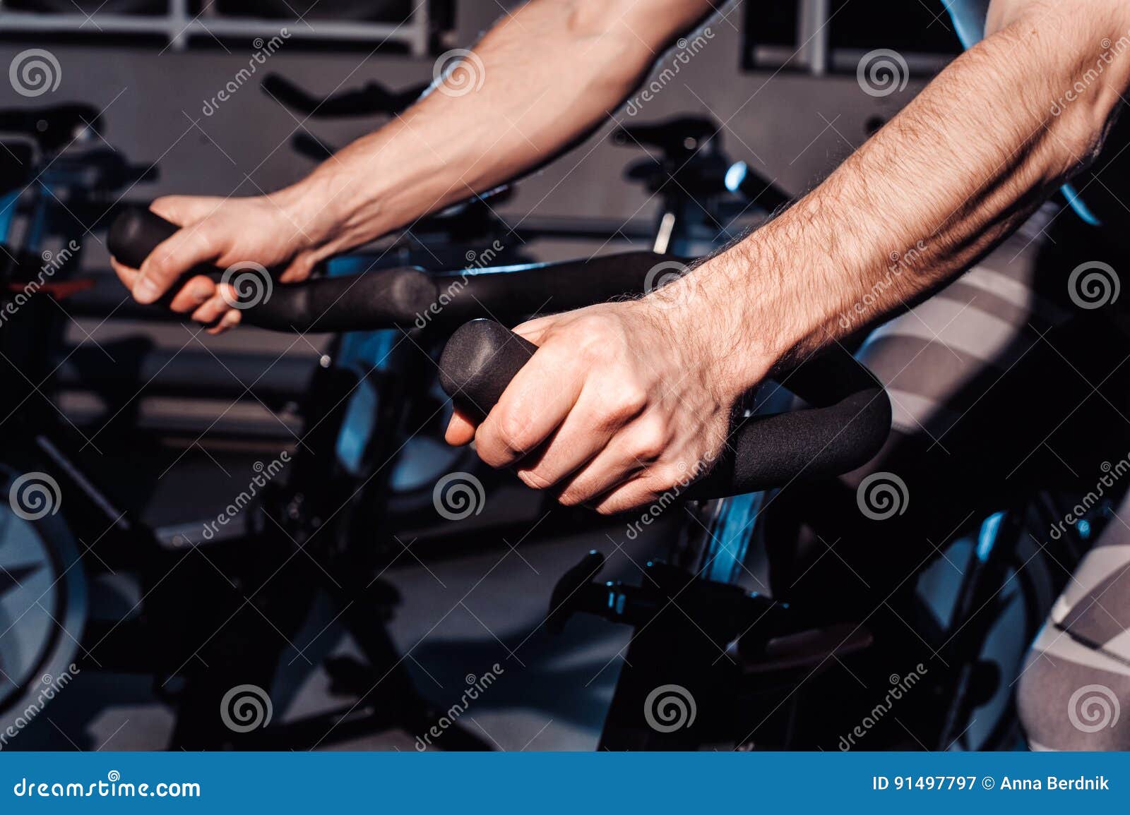 Young Man Riding an Exercise Bike Stock Image - Image of fitness ...